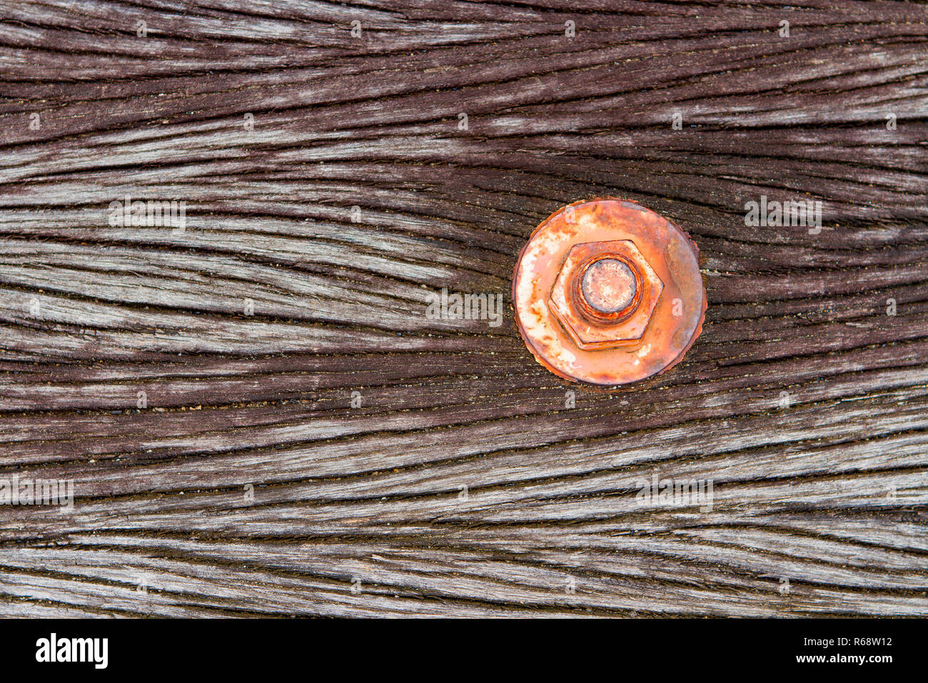 The nut is rust on old wood floor Stock Photo - Alamy