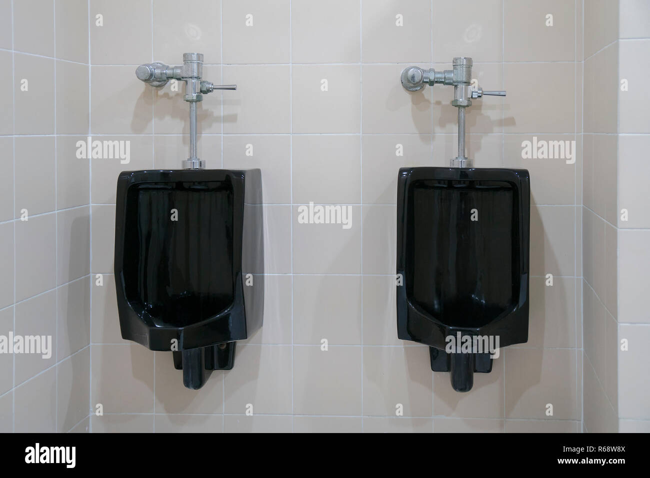 Black urinal of men with tile wall Stock Photo - Alamy