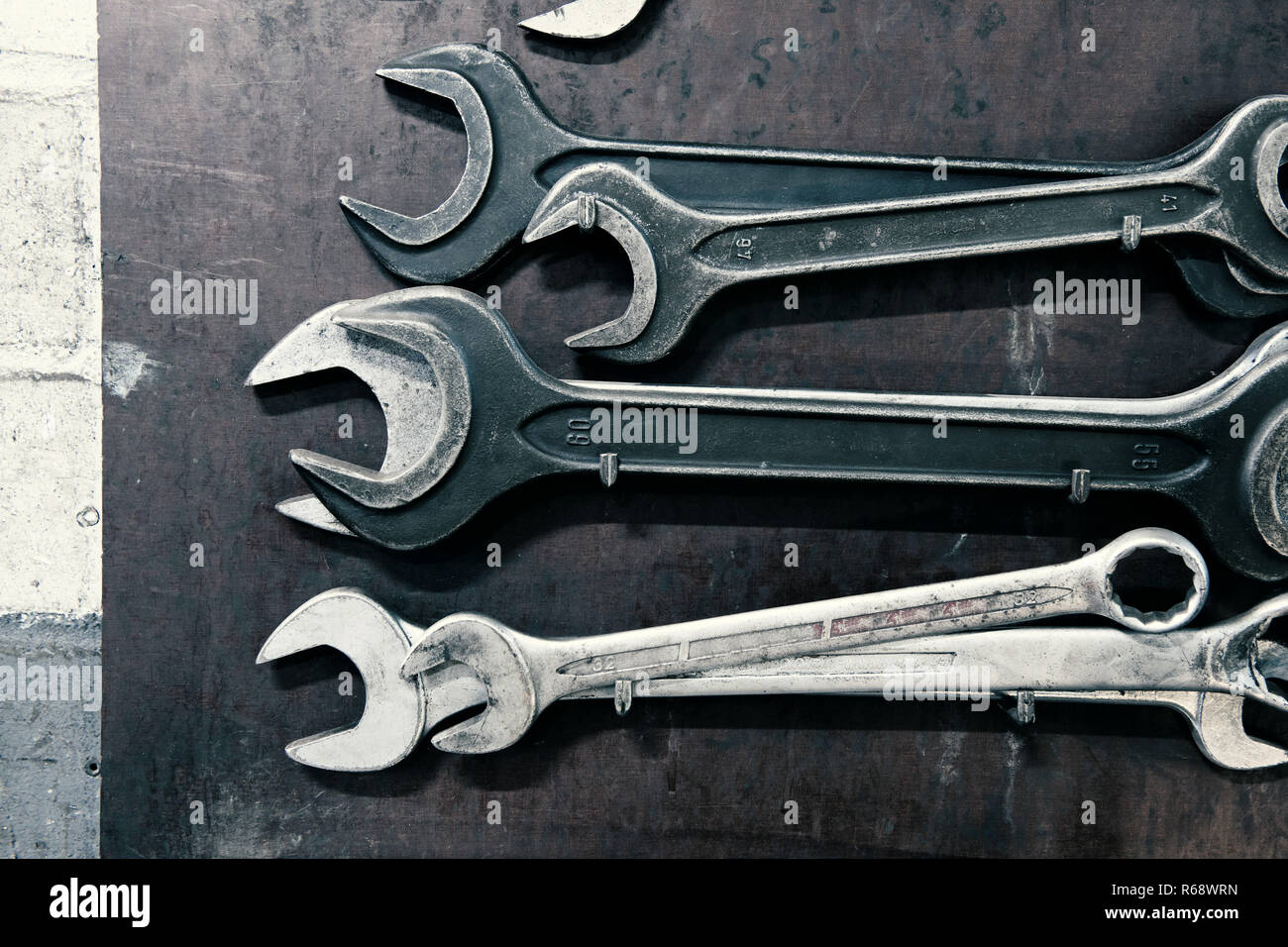 Old used wrenches in the wall shelf Stock Photo - Alamy