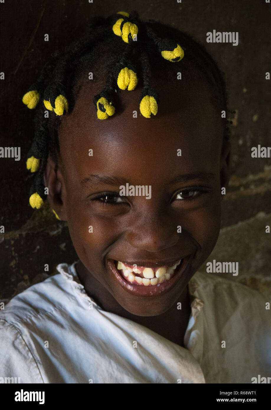 Portrait of a playful girl with Angolan traditional hairstyle, Namibe ...
