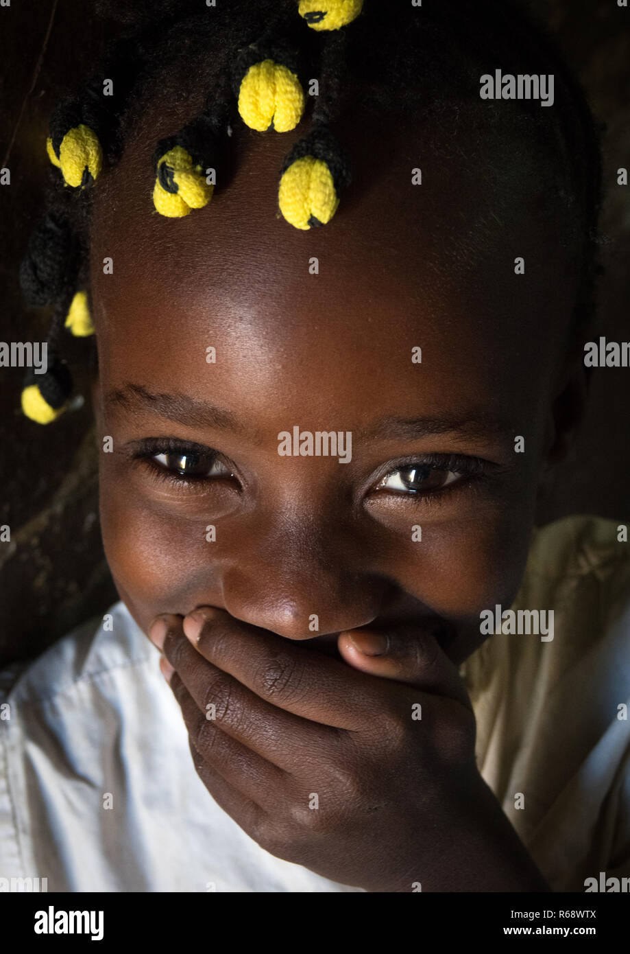 Portrait of a playful girl with Angolan traditional hairstyle, Namibe ...