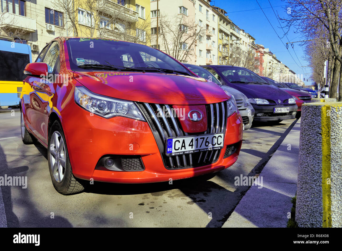 A modern red Chinese car parked on a street in Sofia, the capital of ...