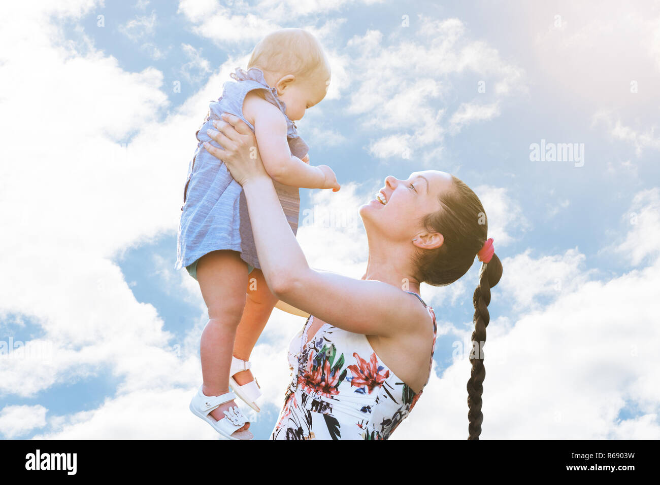 Happy Woman Carrying Baby Stock Photo - Alamy