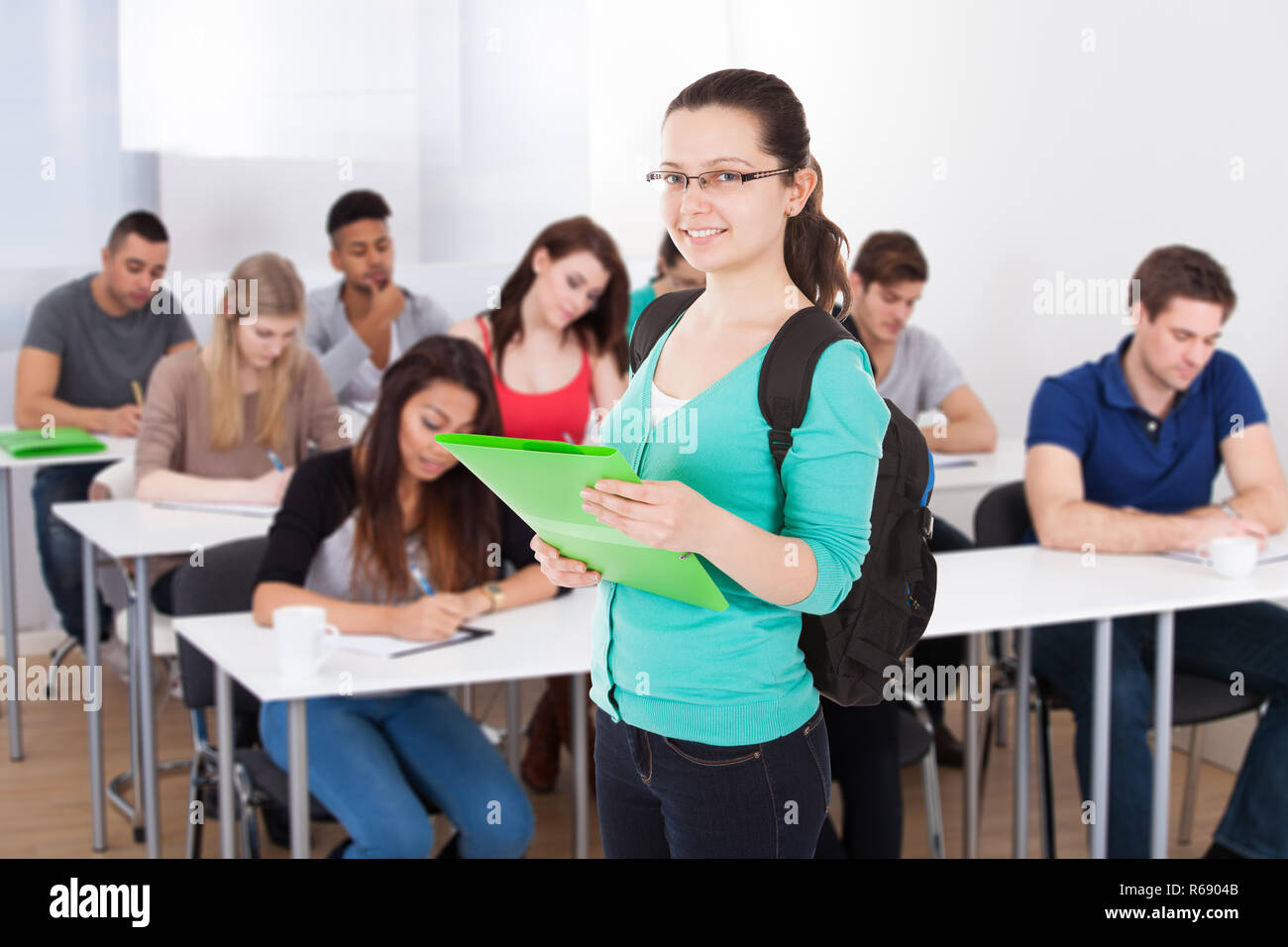 Student Holding File Against White Background Stock Photo - Alamy