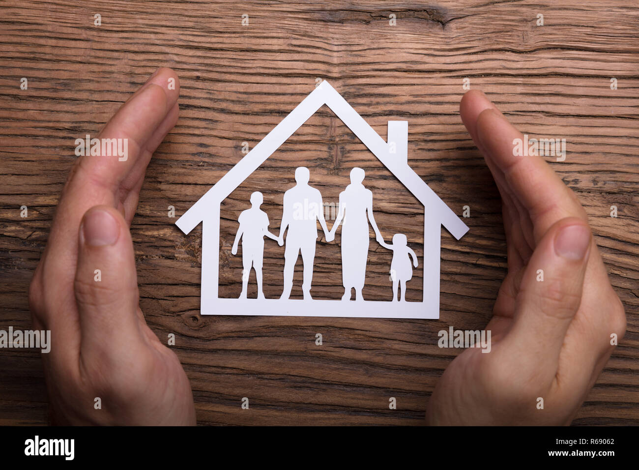 Person protecting family figures hi-res stock photography and images ...