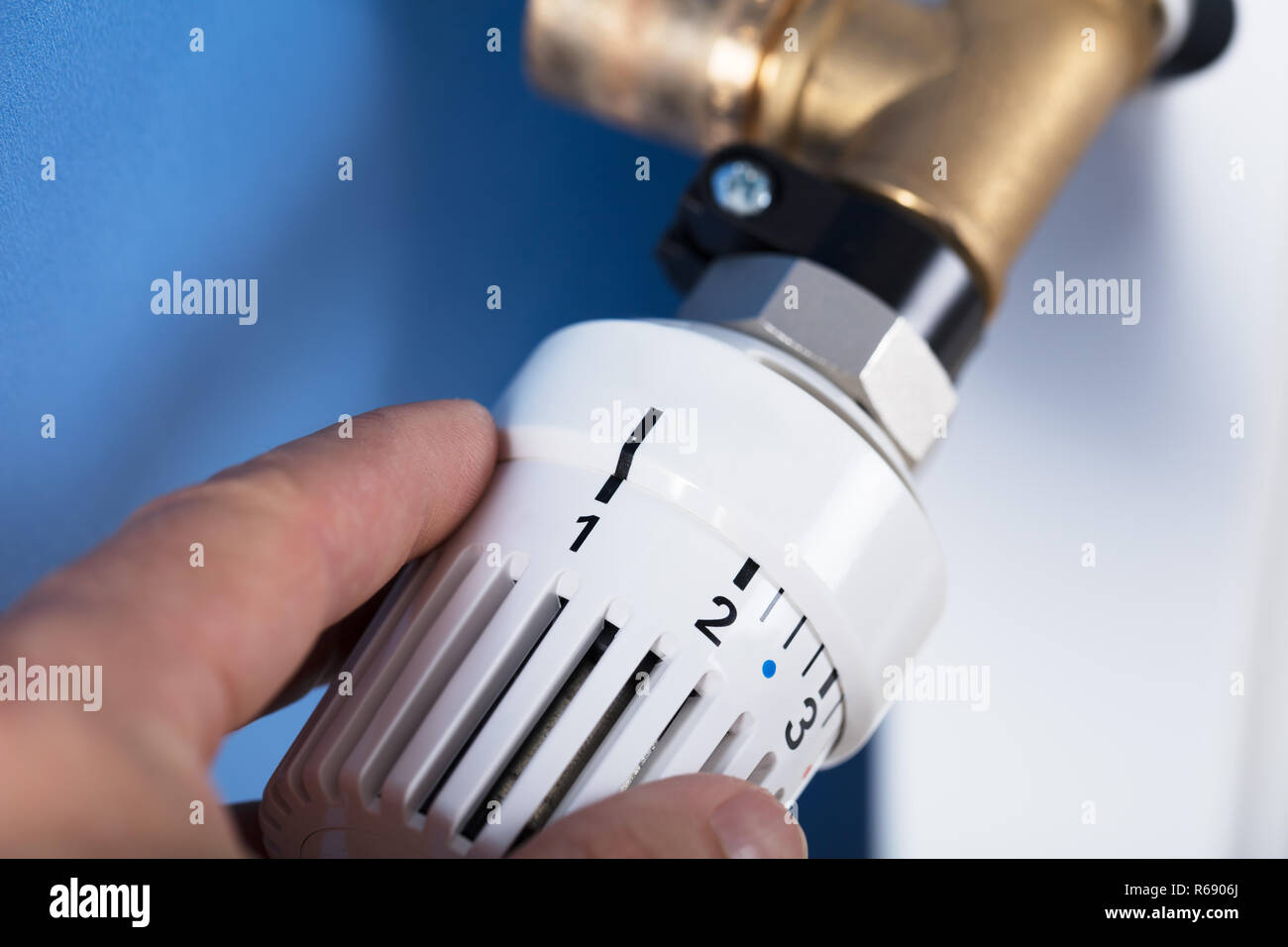 Hand Adjusting Temperature On Thermostat Stock Photo - Alamy