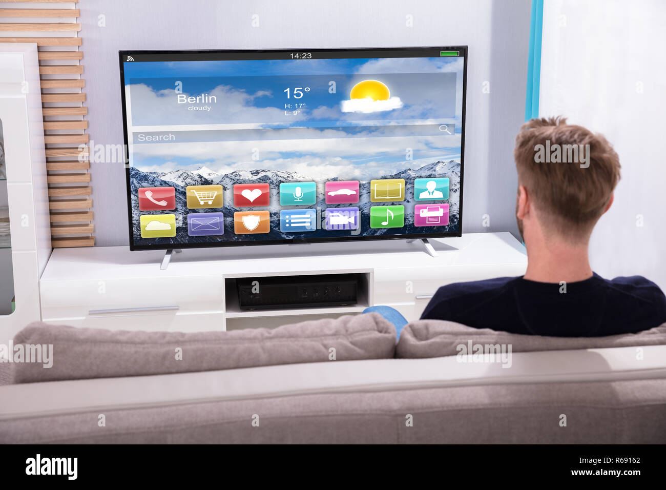 Man Watching Television Showing Colorful Application Stock Photo - Alamy