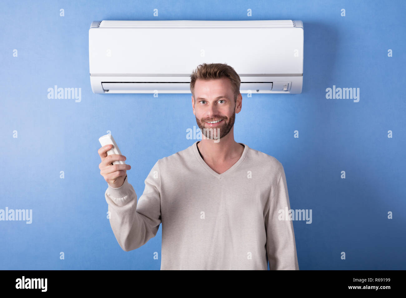 Young Man Standing In Front Of Air Condition Stock Photo - Alamy