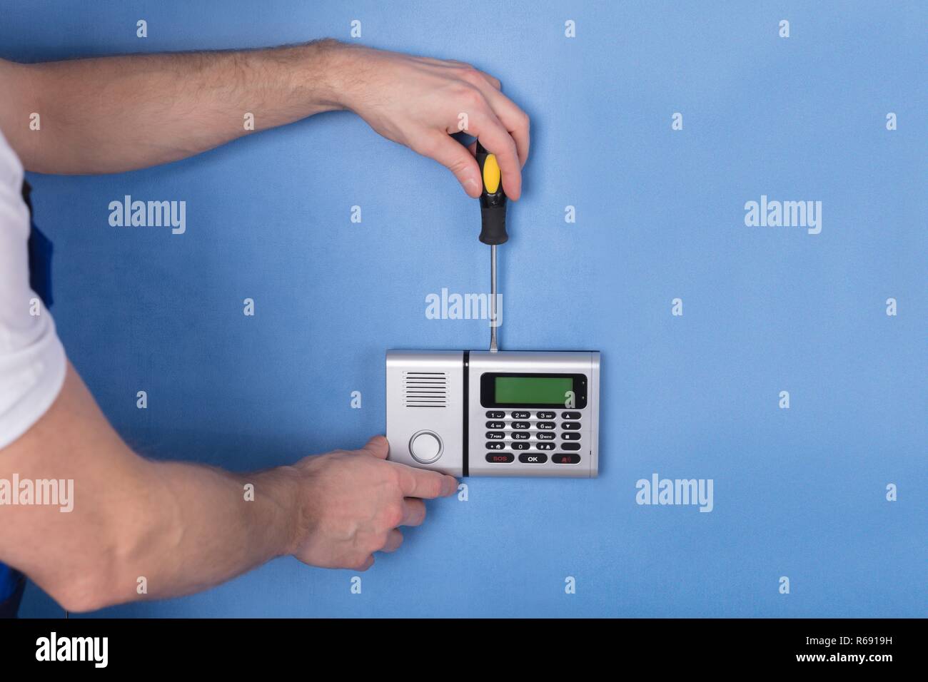 Human Hand Installing Security System Stock Photo - Alamy