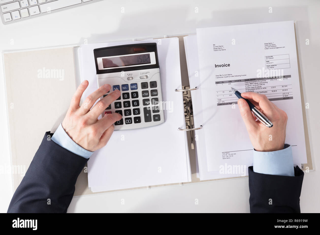 Businessperson Checking Invoice With Calculator Stock Photo - Alamy