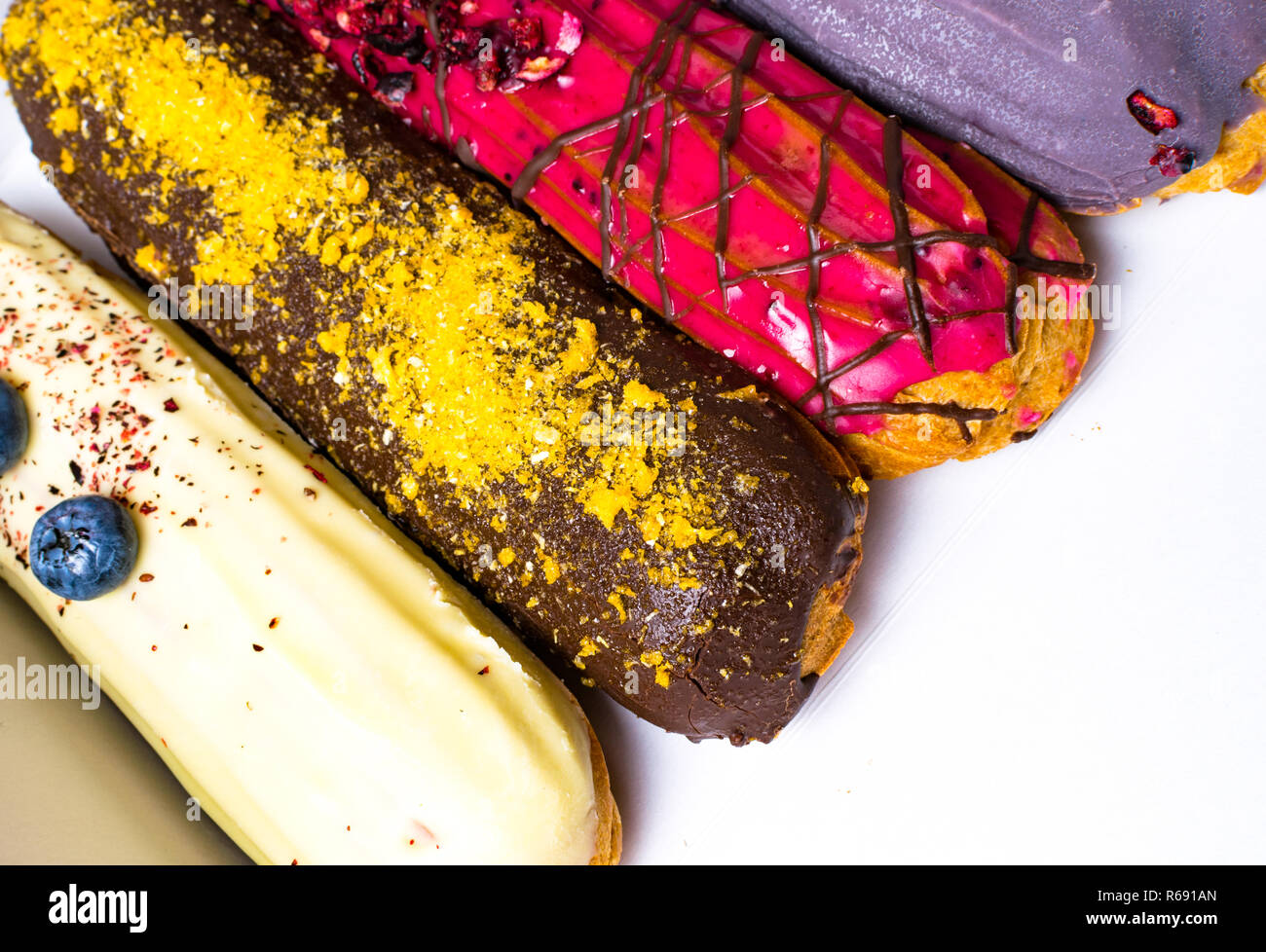 colorful eclairs background isolated on white, copy space Stock Photo ...