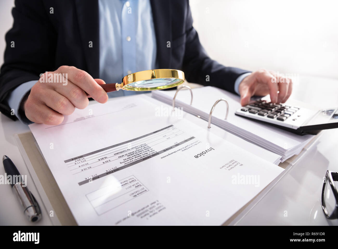 Businessperson Checking Invoice Through Magnifying Glass Stock Photo ...