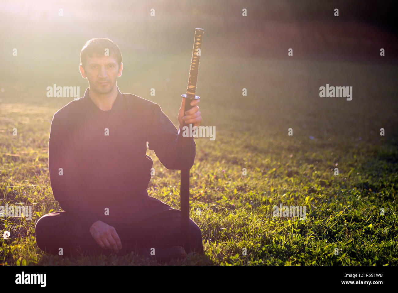 sitting ninja with sword Stock Photo - Alamy