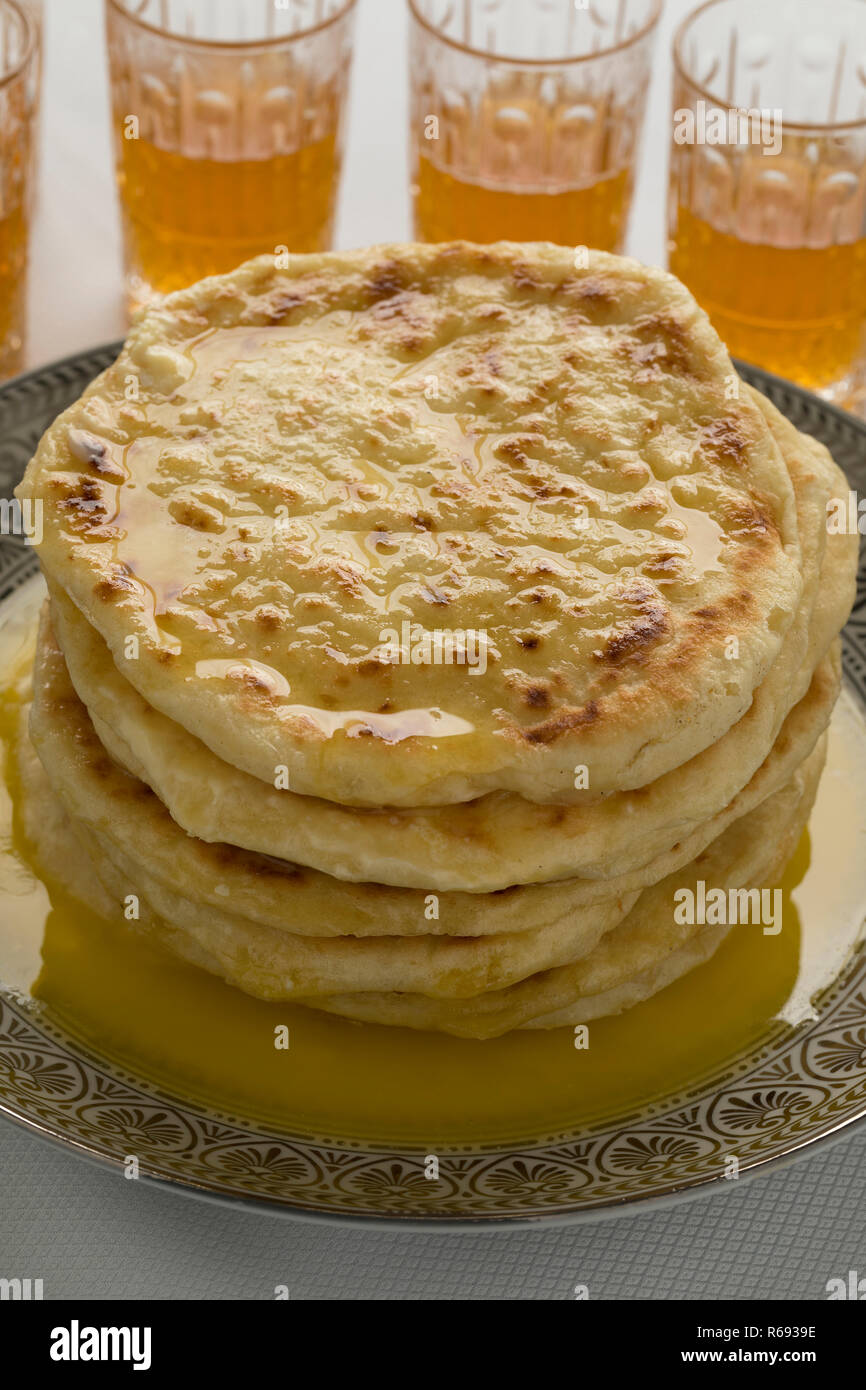 Stack of traditional Moroccan meloui pancakes topped with butter and ...