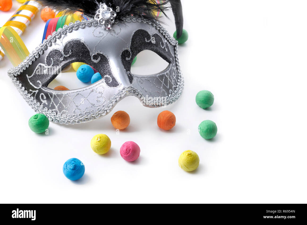 carnival mask among colorful cotillon on white background Stock Photo ...