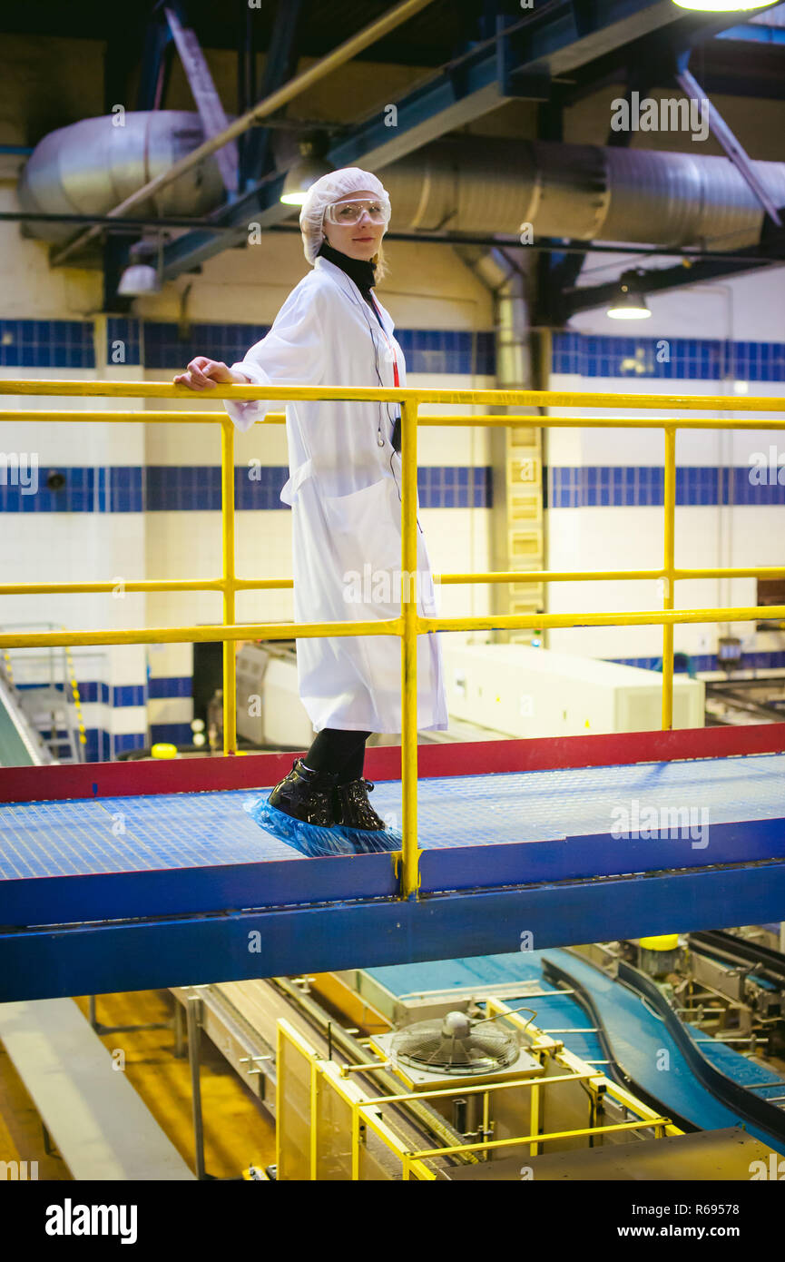 Female worker on the production line of beer factory. portrait of a ...