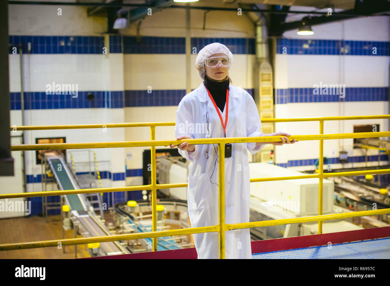 Female worker on the production line of beer factory. portrait of a ...