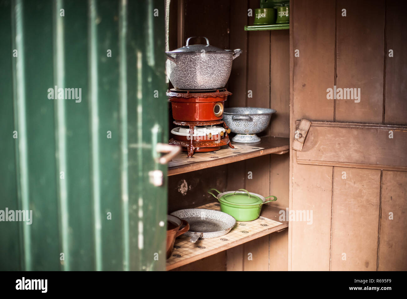 . The authentic kitchen utensils. Vintage kettle and old kerosene stove ...