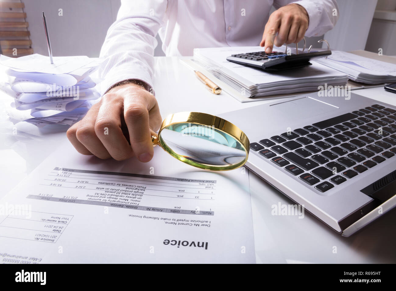 Auditor Checking Invoice Using Magnifying Glass Stock Photo - Alamy
