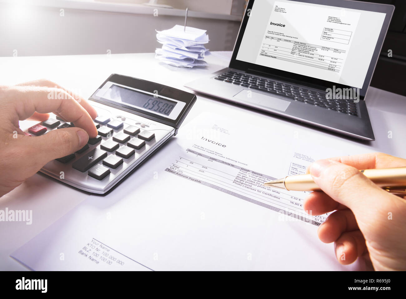 Businessperson's Hand Calculating Invoice Stock Photo - Alamy