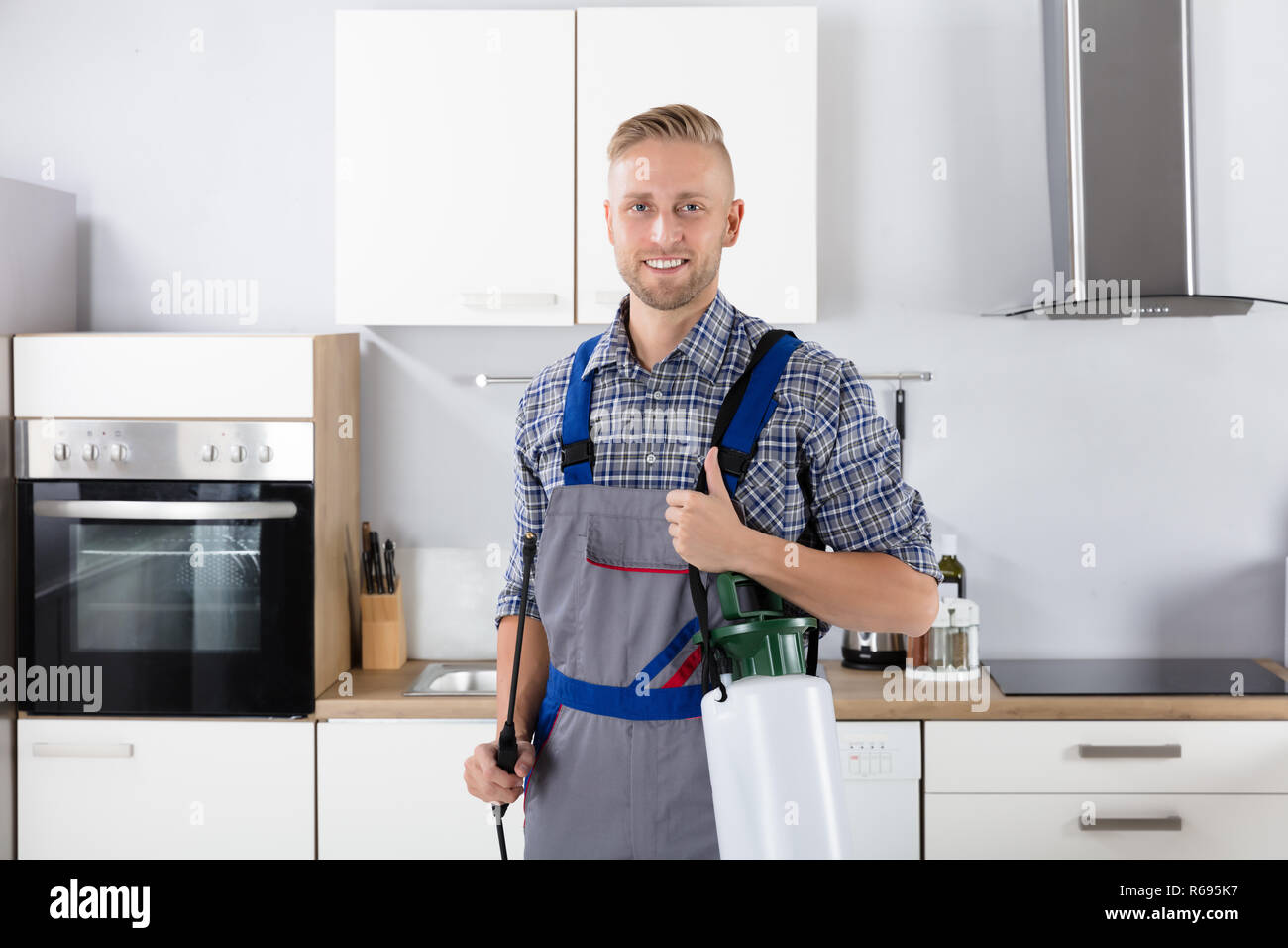 Confident Pest Control Worker With Pesticide Container Stock Photo - Alamy