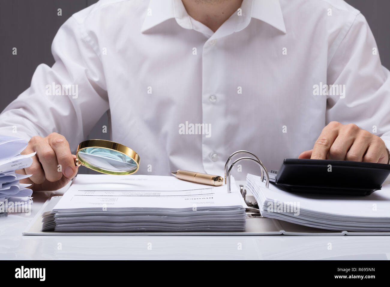 Businessman Examining Invoice With Magnifying Glass Stock Photo - Alamy