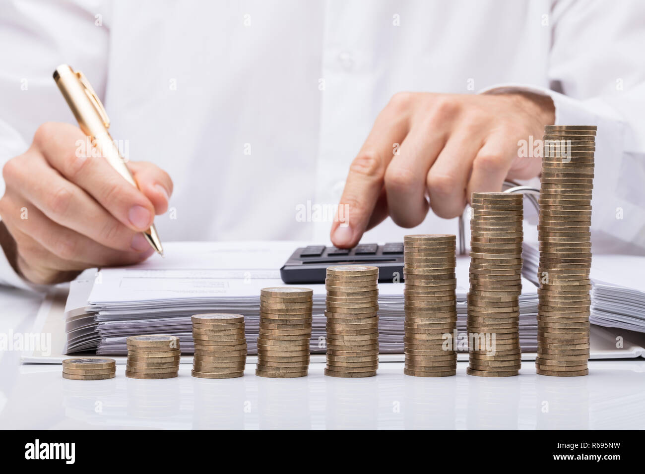 Accountant calculating dollars calculator hi-res stock photography and ...