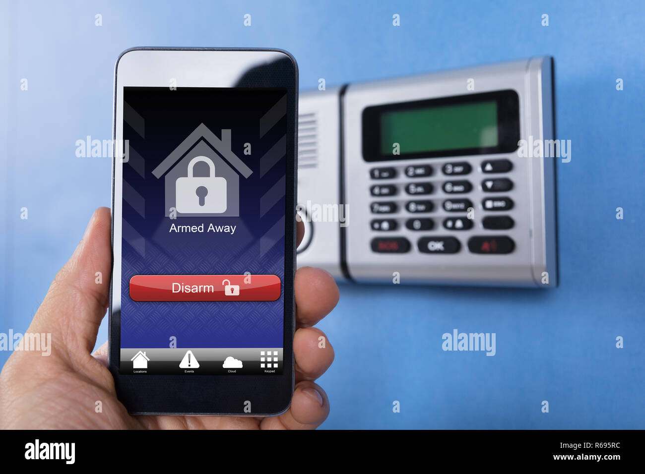 Hand Holding Smartphone For Disarming The System Stock Photo - Alamy