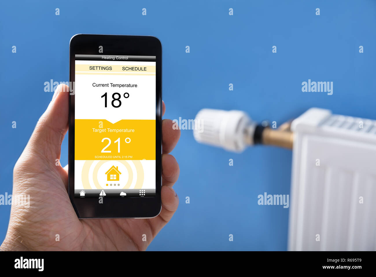 Person Hand Setting Temperature Of Thermostat Using Mobilephone Stock ...