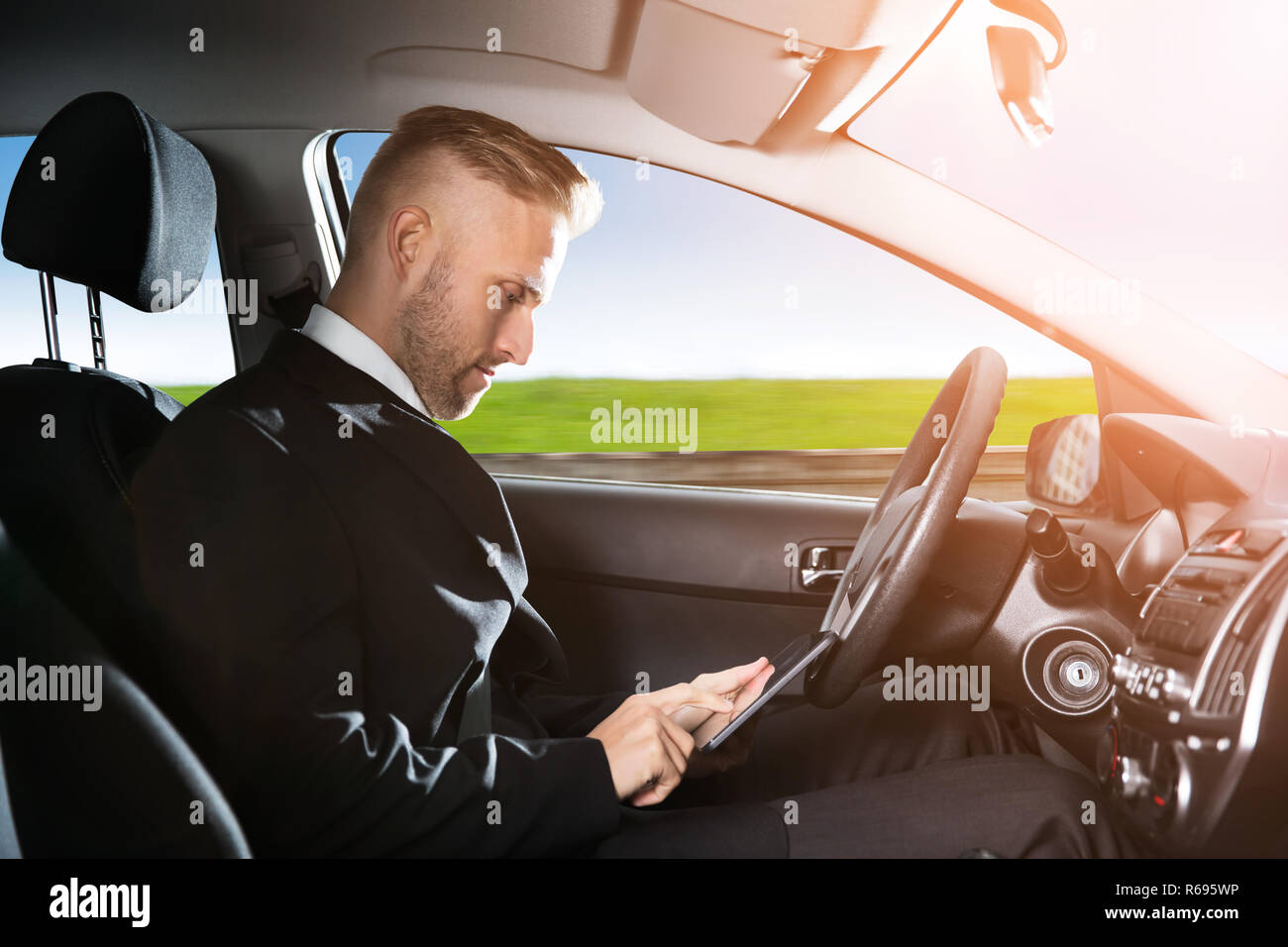 Businessman Sitting Inside Self Driving Car Stock Photo - Alamy
