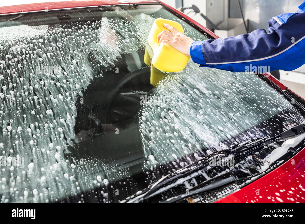 Hand Cleaning Car Windshield With Sponge Stock Photo - Alamy