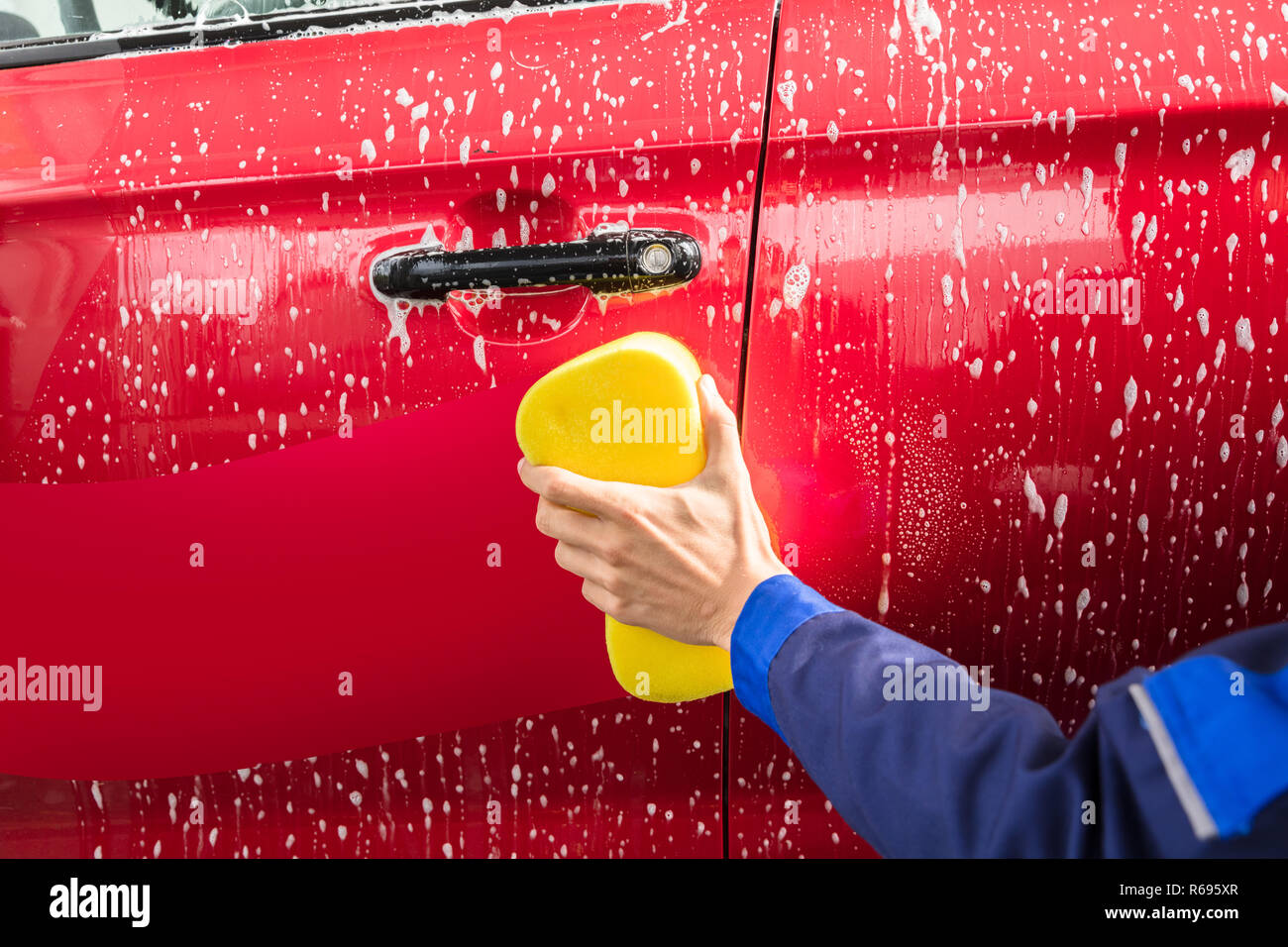 Worker's Hand Washing Red Car With Yellow Sponge Stock Photo - Alamy