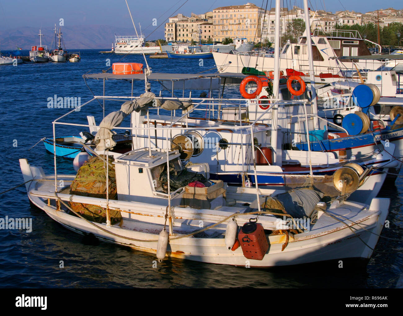 traditional greek fishing boat in blue waters Stock Photo - Alamy