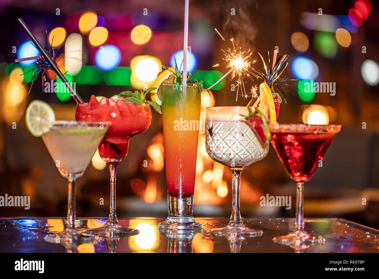 Alcoholic cocktail row on bar table, colorful party drinks Stock Photo ...