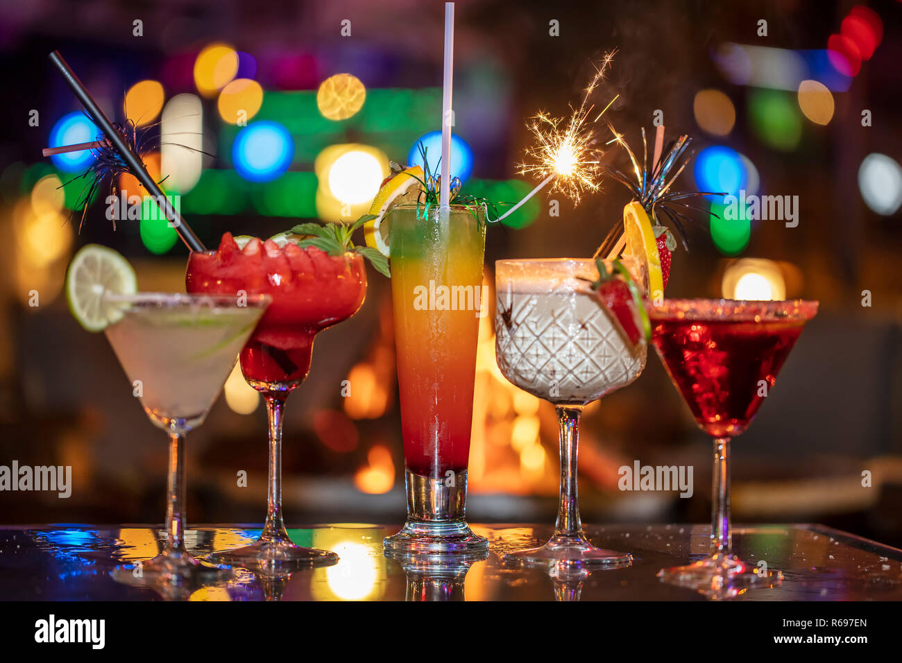 Alcoholic cocktail row on bar table, colorful party drinks Stock Photo ...