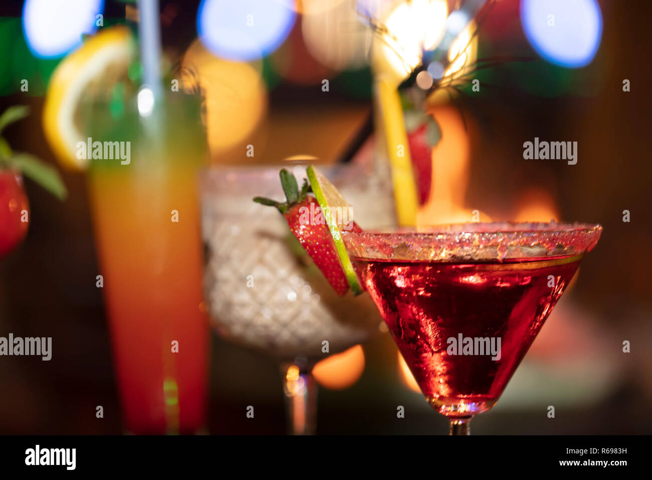 Alcoholic cocktail row on bar table, colorful party drinks Stock Photo ...