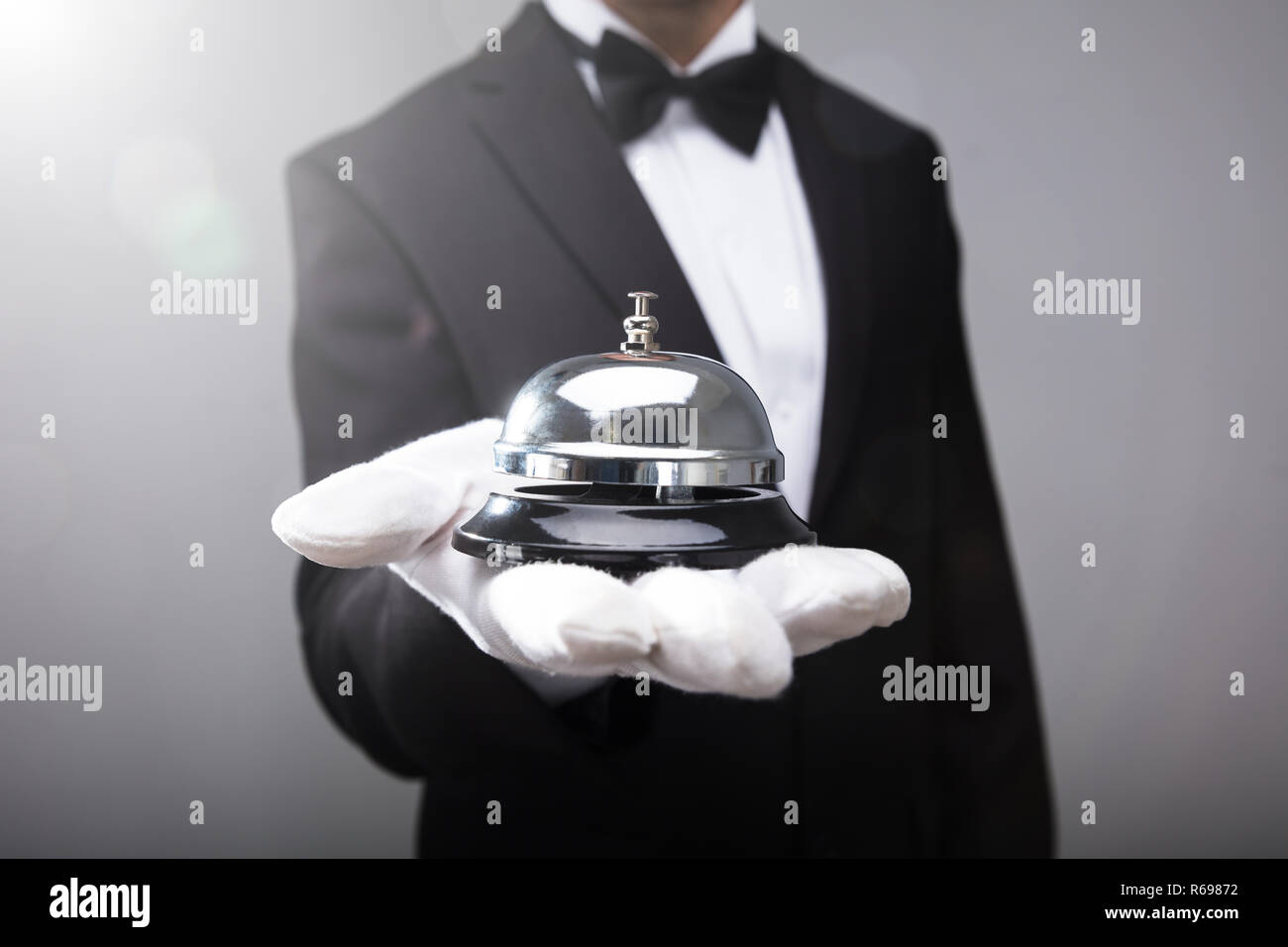 Waiter Holding Service Bell Stock Photo - Alamy