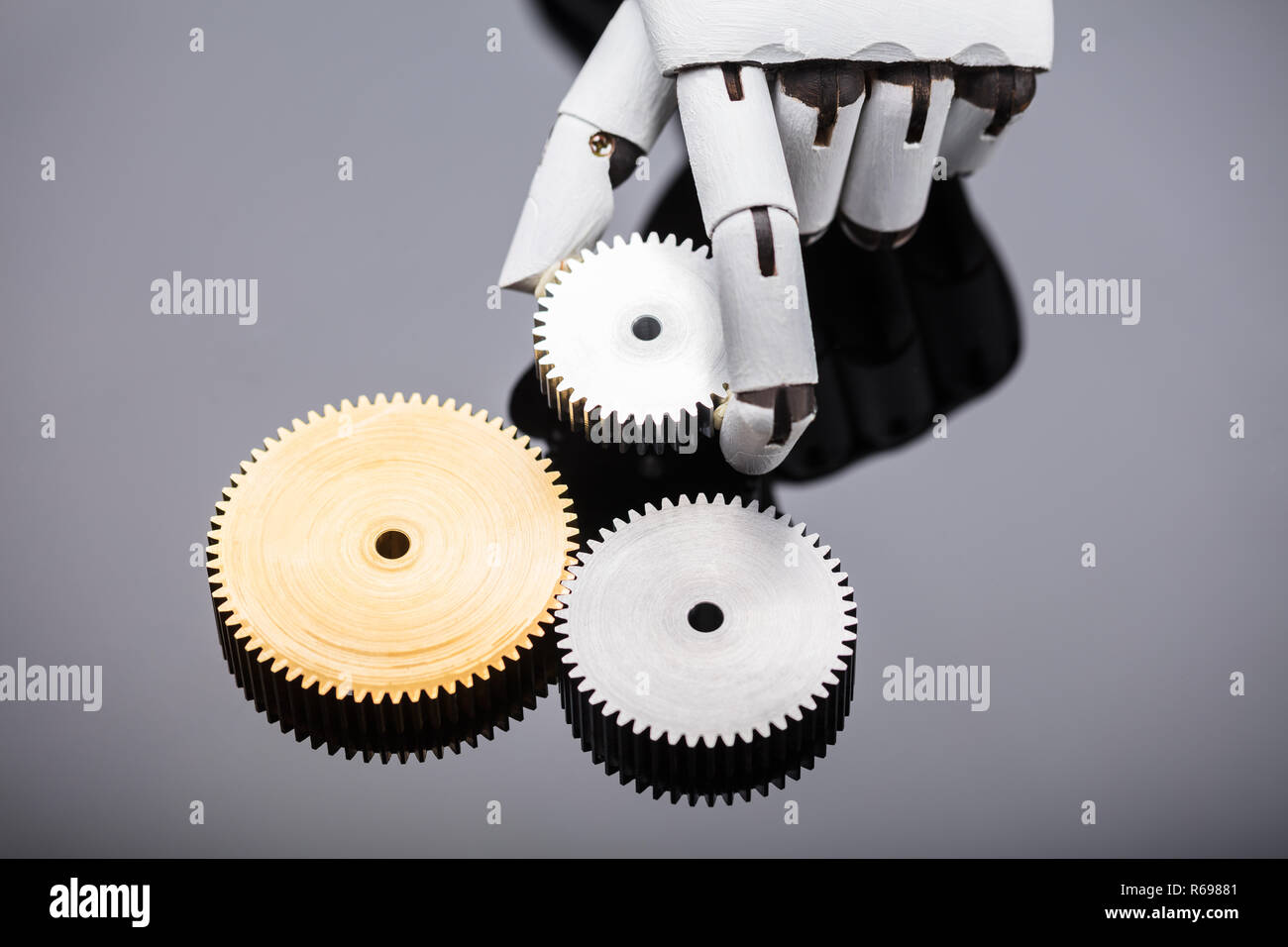 Robot Holding Metal Gear Stock Photo - Alamy