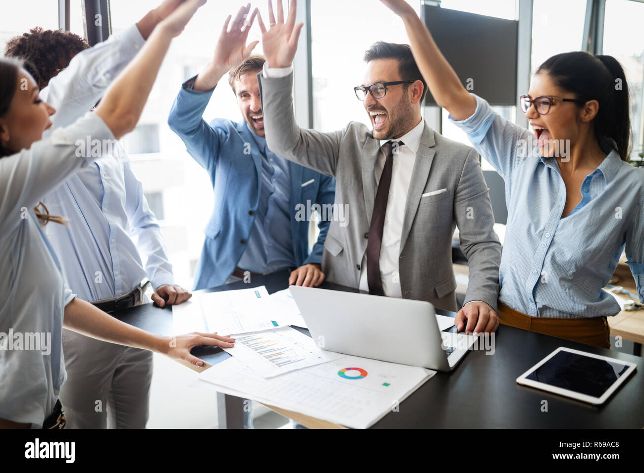 Business team celebrating a good job in the office Stock Photo - Alamy