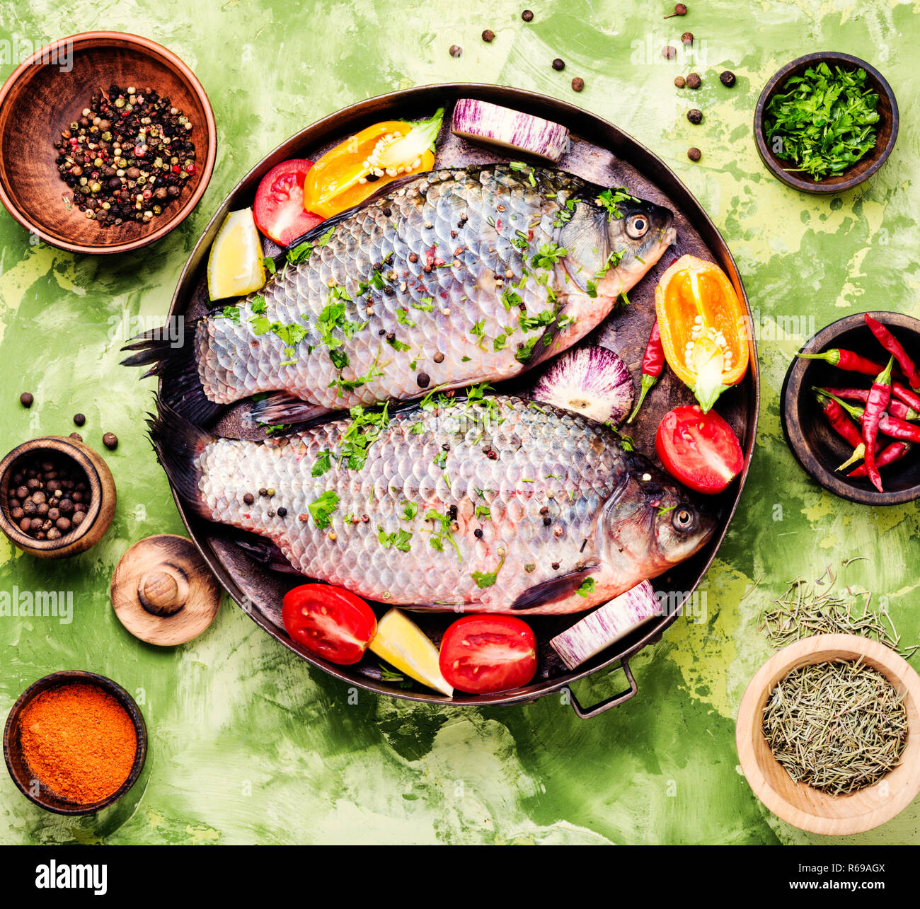Fresh fish carp with ingredients for cooking on pan.Fish food Stock ...