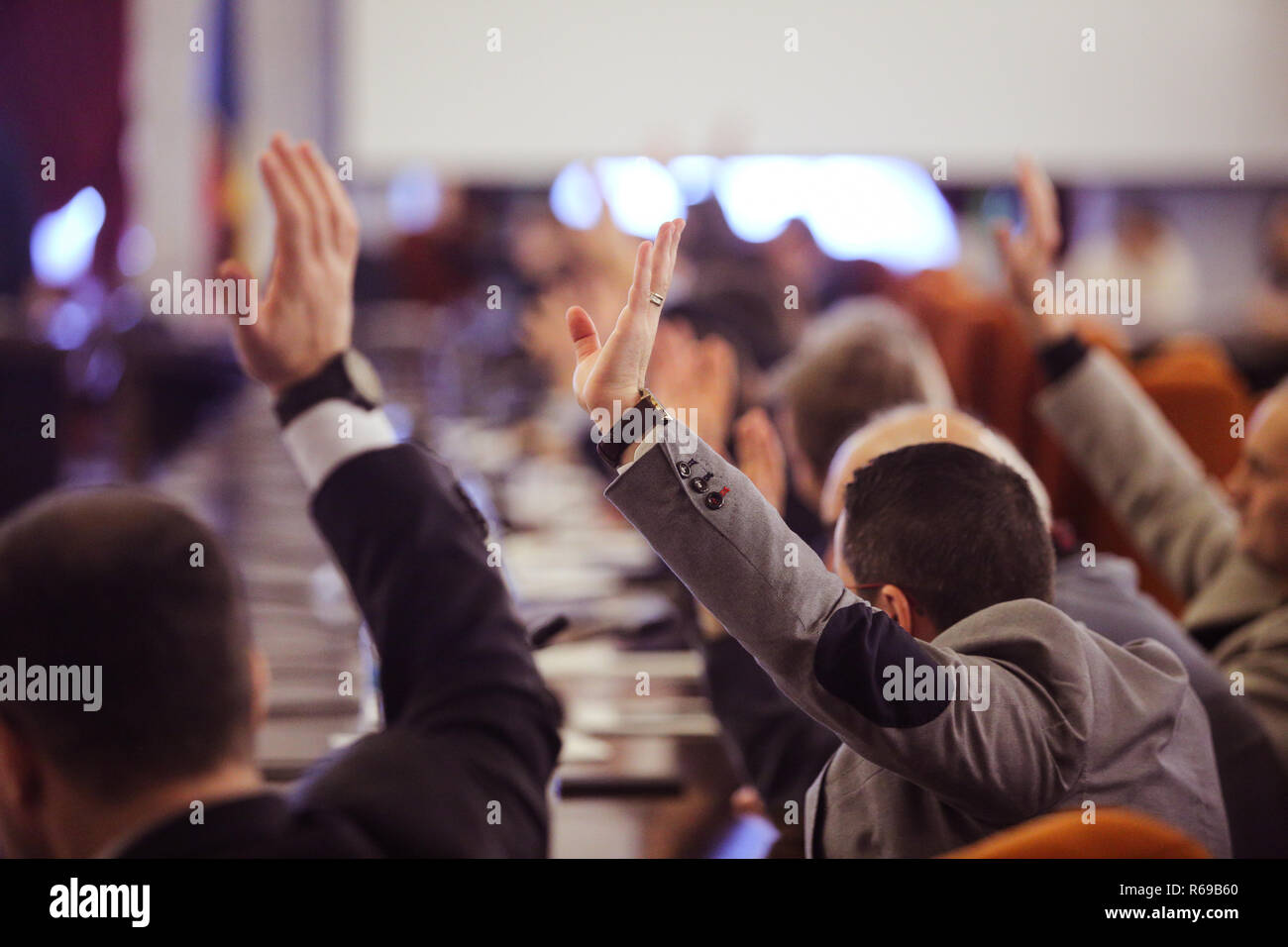 Members of Romanian Parliament vote by raising their hands Stock Photo ...