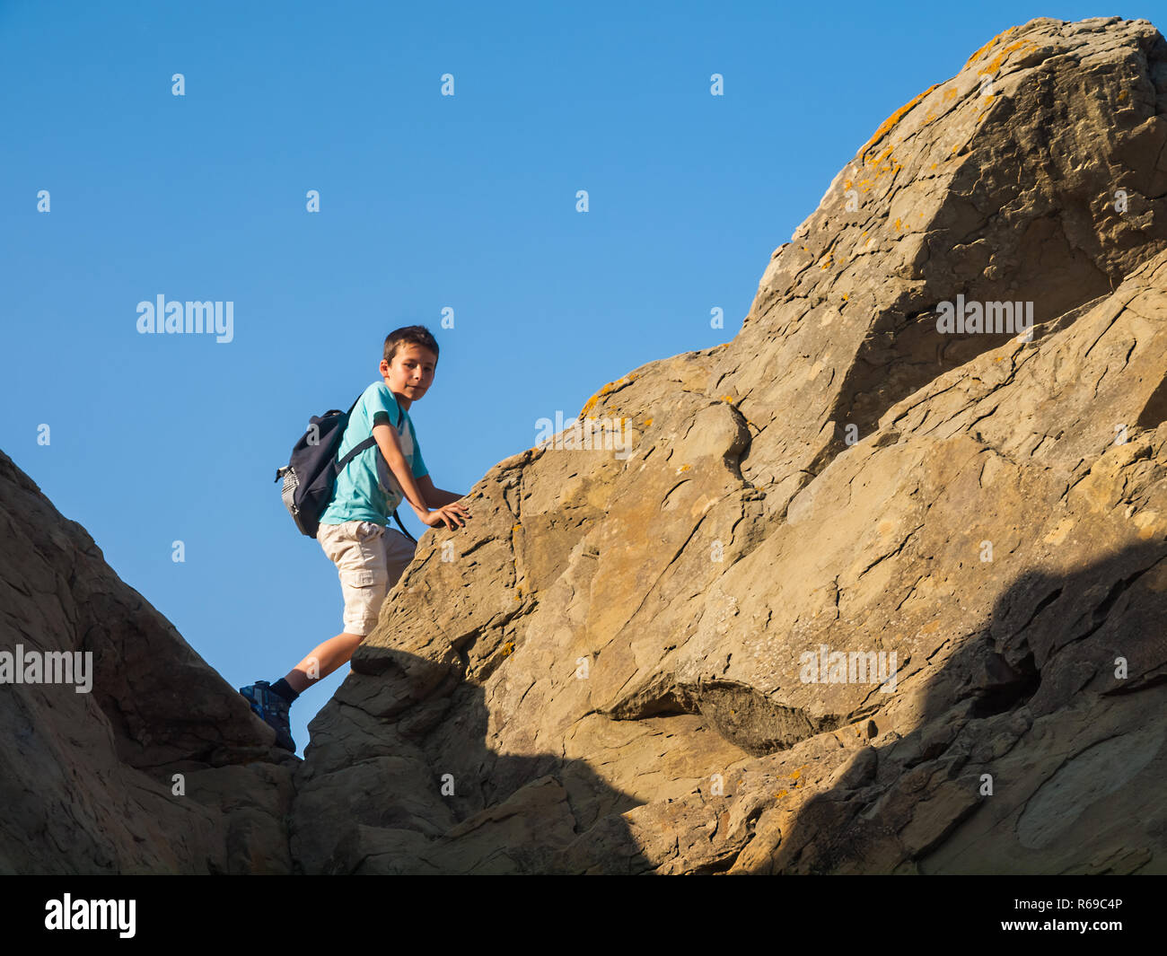 Boys climbing a rock hi-res stock photography and images - Alamy