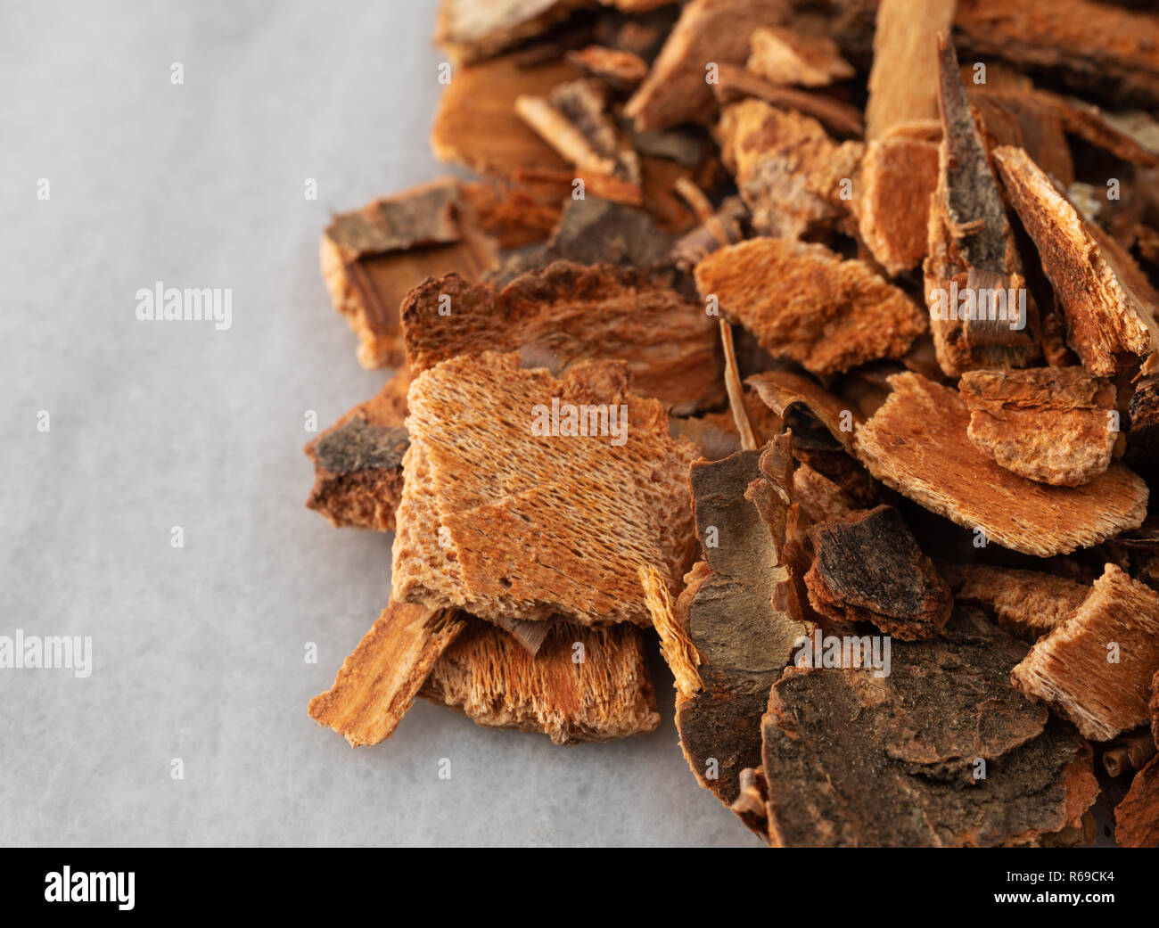 Close view of a small pile of wild cut cherry tree bark on a gray ...