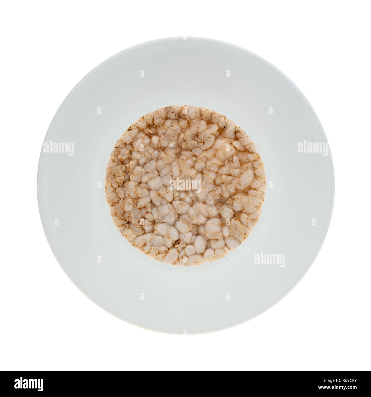 Top view of a single multigrain rice cake on a plate isolated on a ...