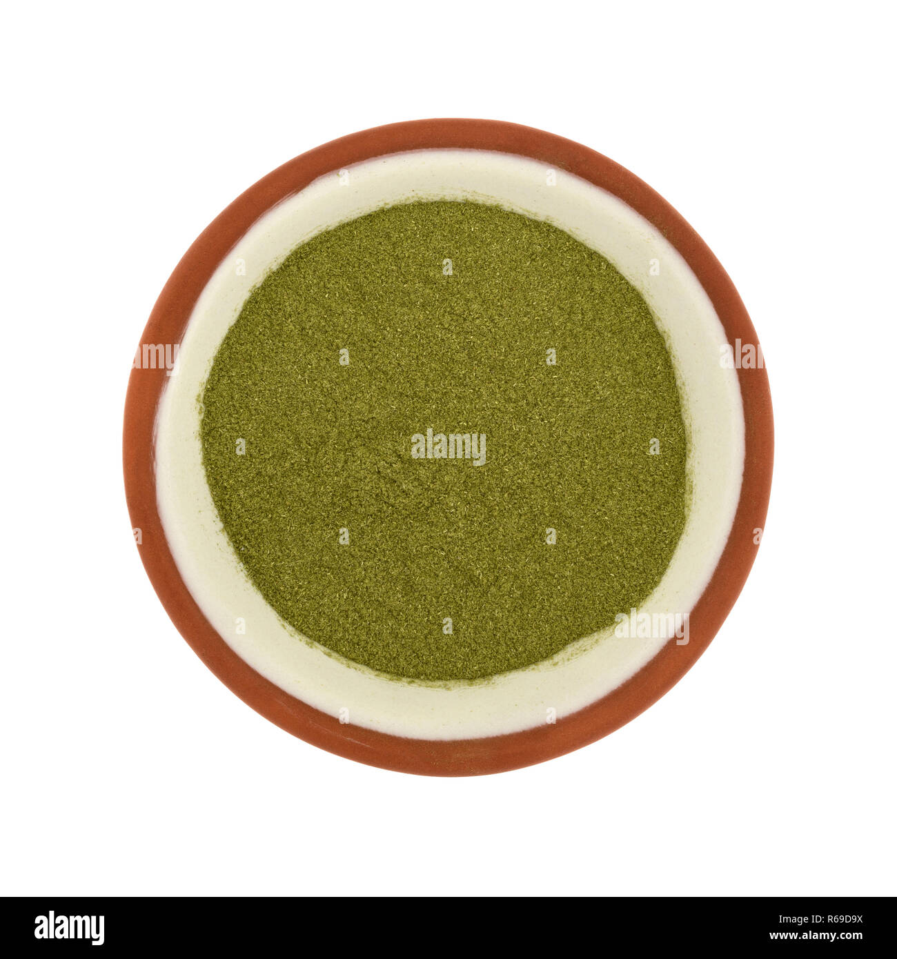 Top view of a portion of organic powdered wheat grass in a small bowl ...