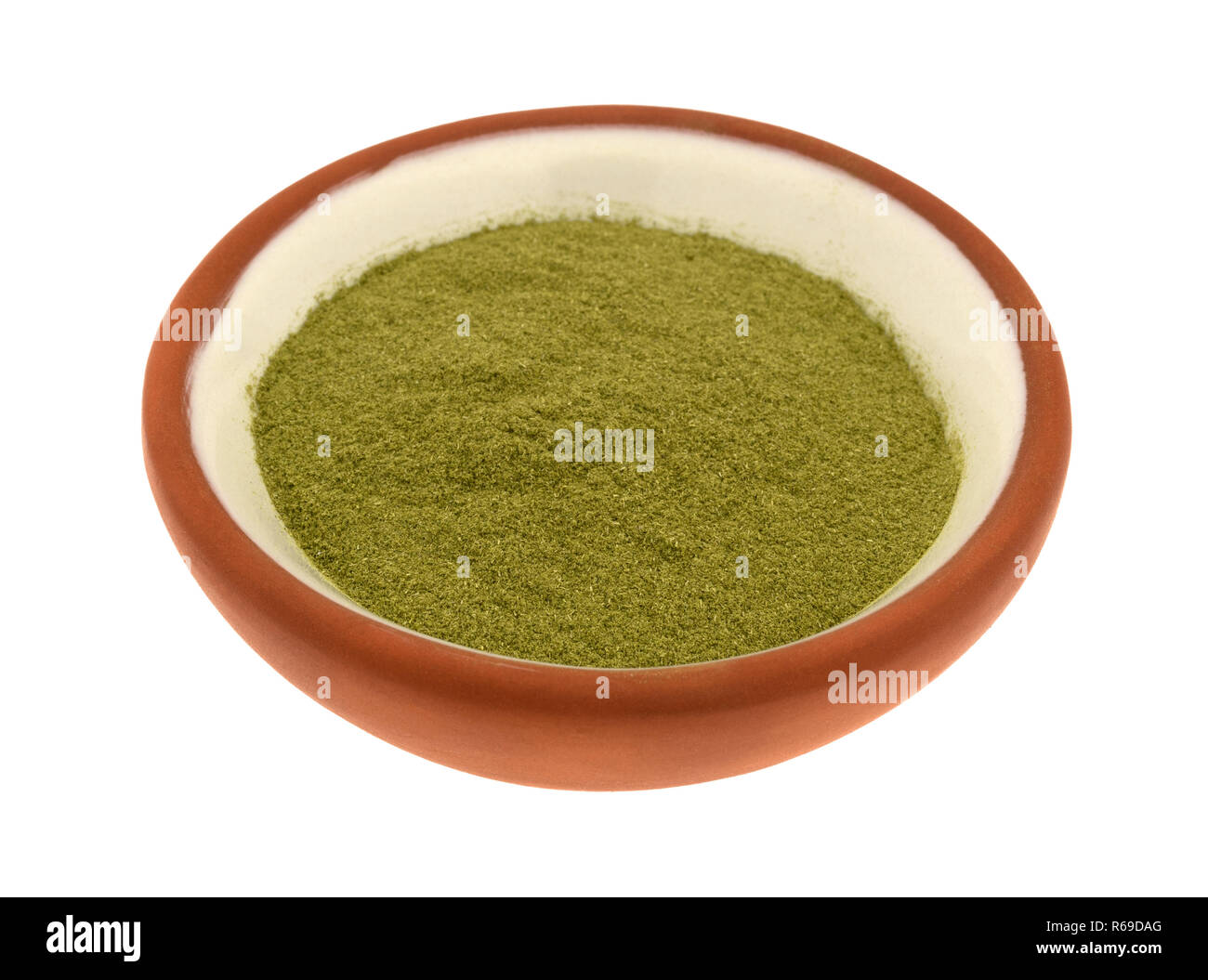 Side view of a portion of organic powdered wheat grass in a small bowl ...