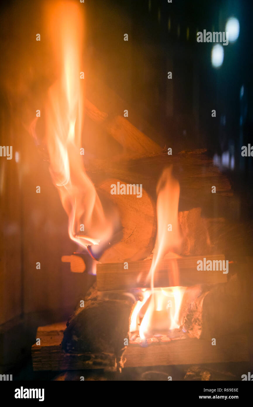 Blazing Flames Behind The Screen Of A Fireplace Stock Photo - Alamy