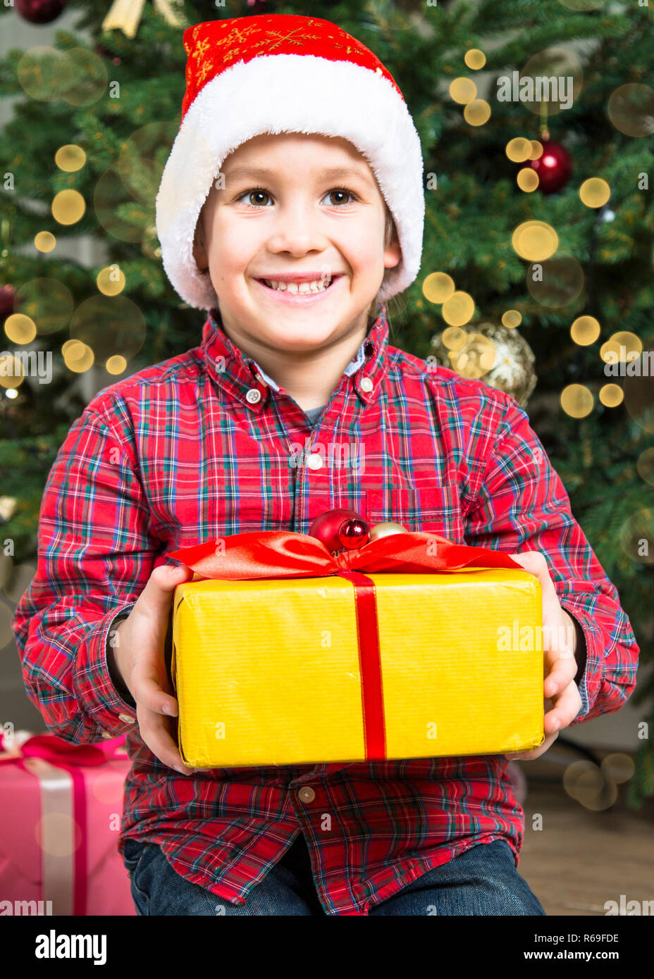 Christmas child with present box Stock Photo - Alamy