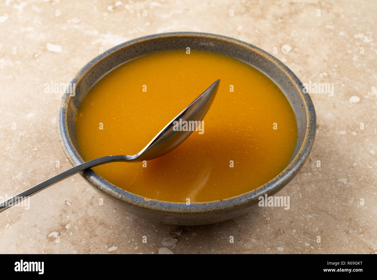 Side view of a bowl of freshly made butternut squash soup with a spoon ...