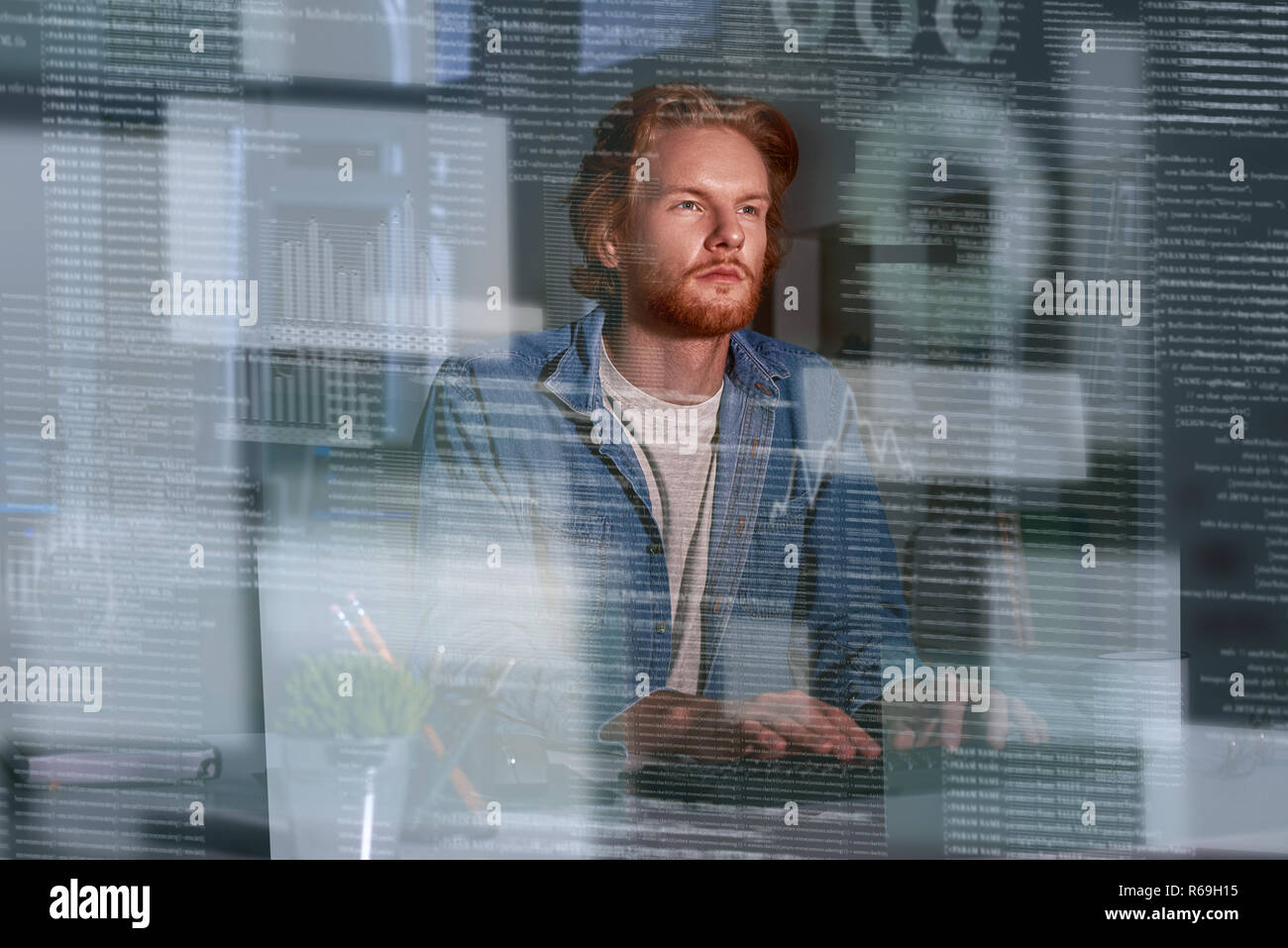 Young concentrated computer developer writing new code Stock Photo - Alamy